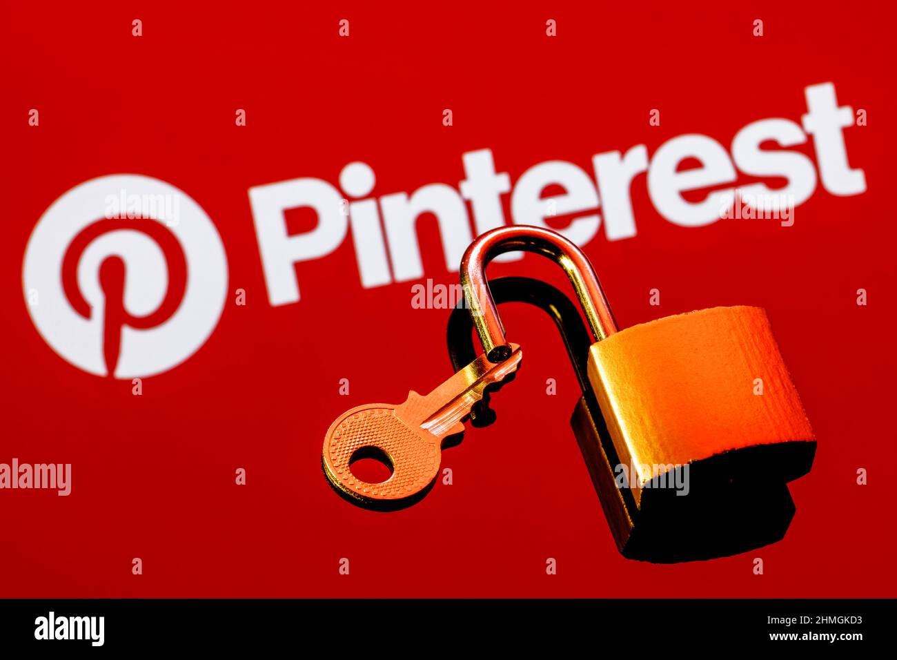 An open security lock and key on background of Pinterest social media ...