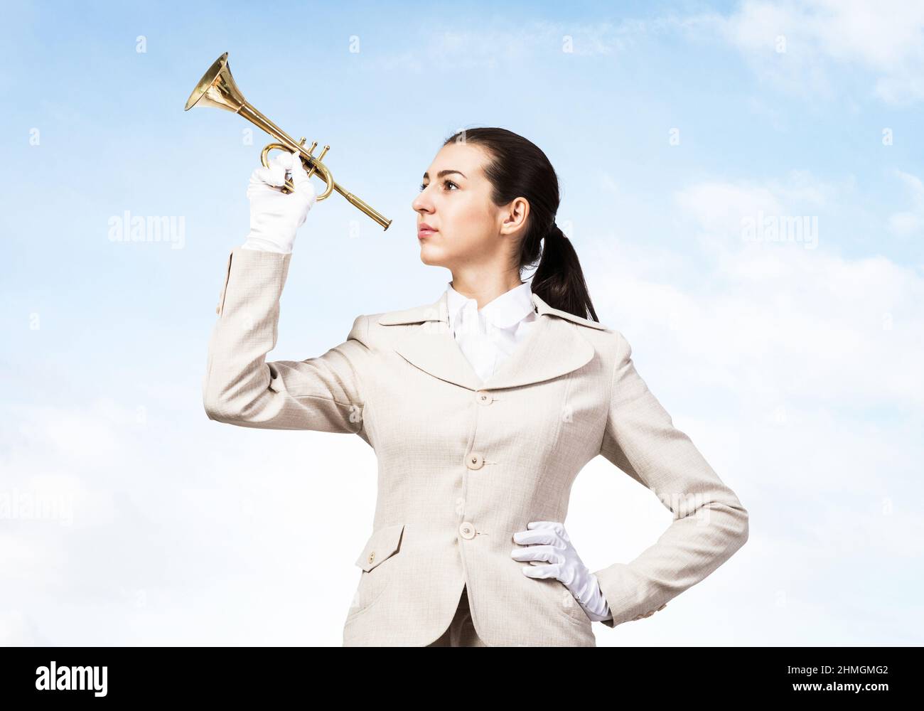Beautiful woman playing trumpet brass Stock Photo - Alamy