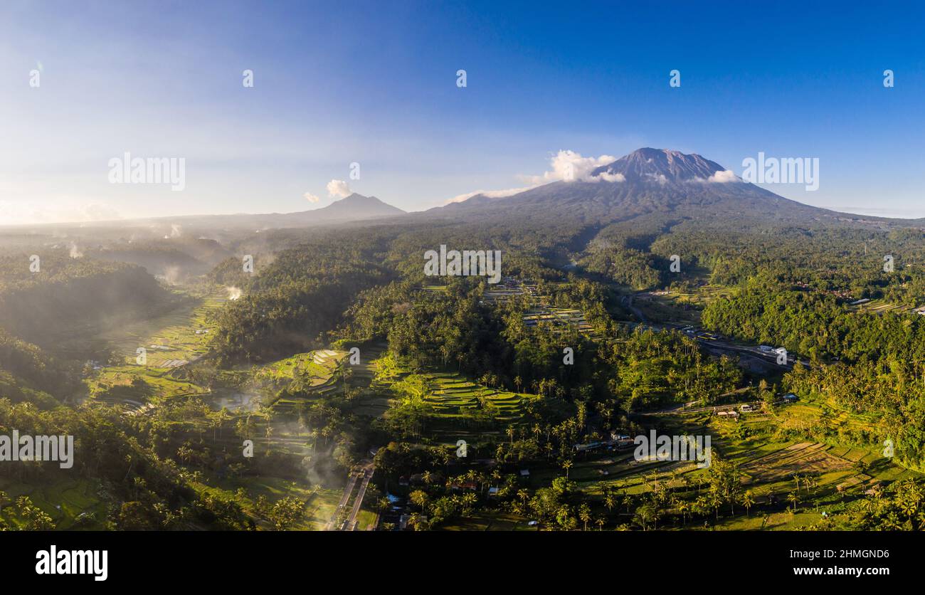 Dramatic aerial view of the Mt Agung volcano overlooking a terrace rice ...