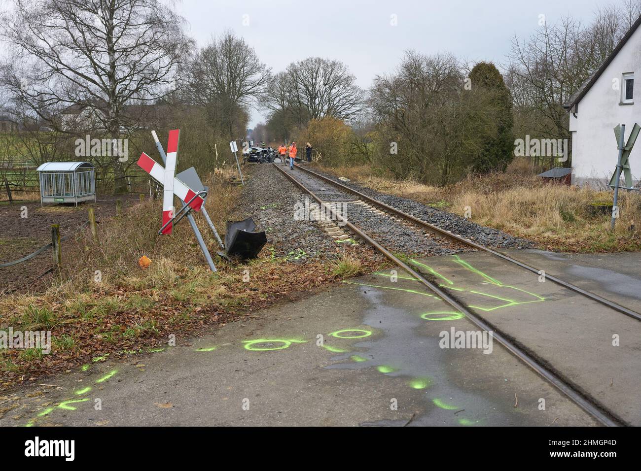 Dierdorf, Germany. 10th Feb, 2022. Helpers stand by the wrecked vehicle ...