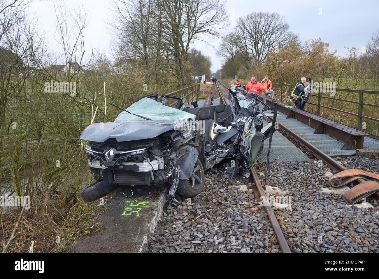 Dierdorf, Germany. 10th Feb, 2022. Helpers stand behind the wrecked ...