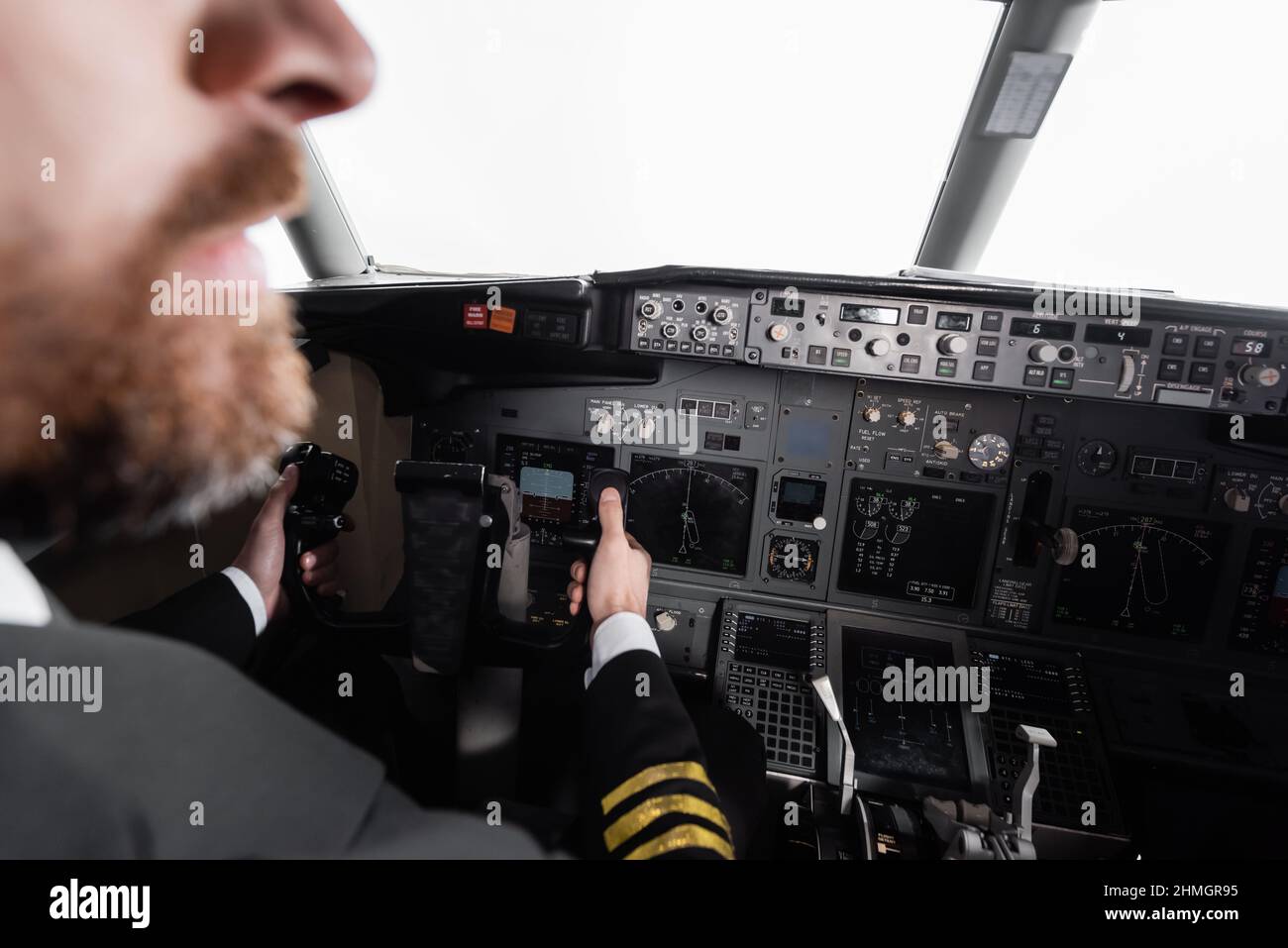 cropped view of bearded pilot using yoke in airplane simulator Stock ...