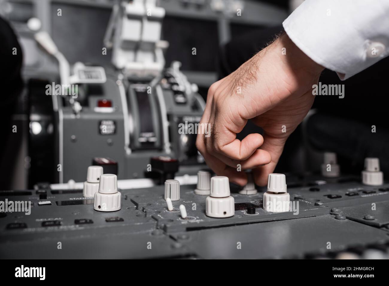 cropped view of pilot using switcher on control panel in airplane Stock ...
