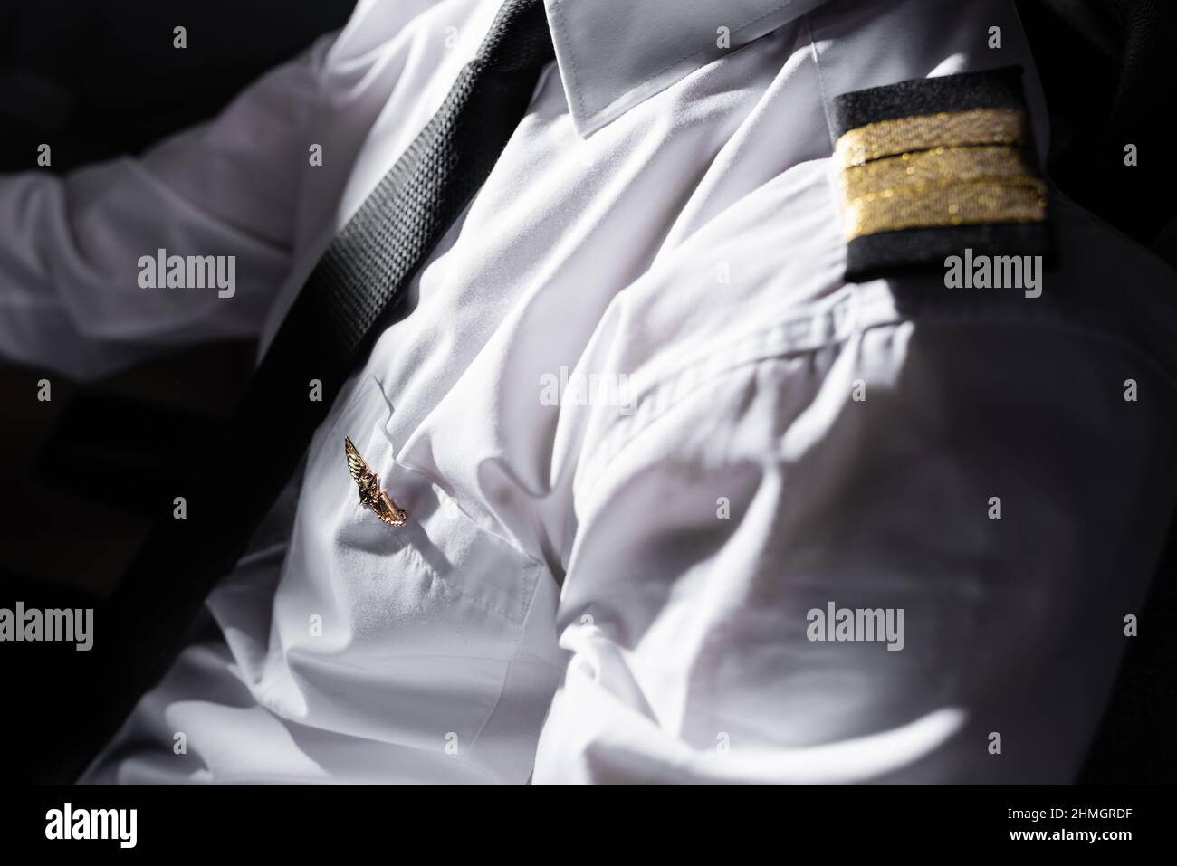 sunshine on badge and uniform on professional pilot in airplane Stock ...