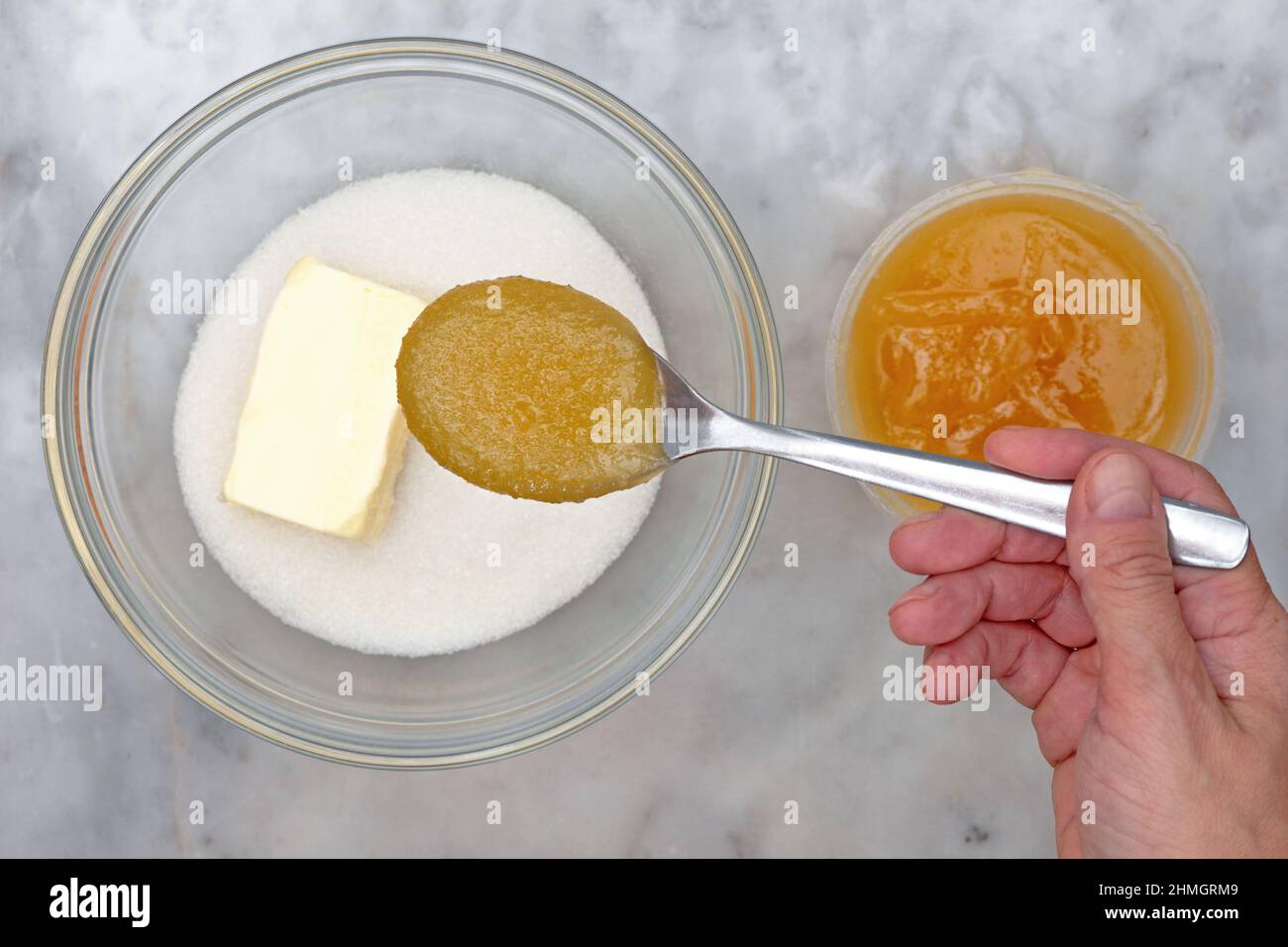 Top view of woman hand putting spoon of honey in sugar and butter in ...