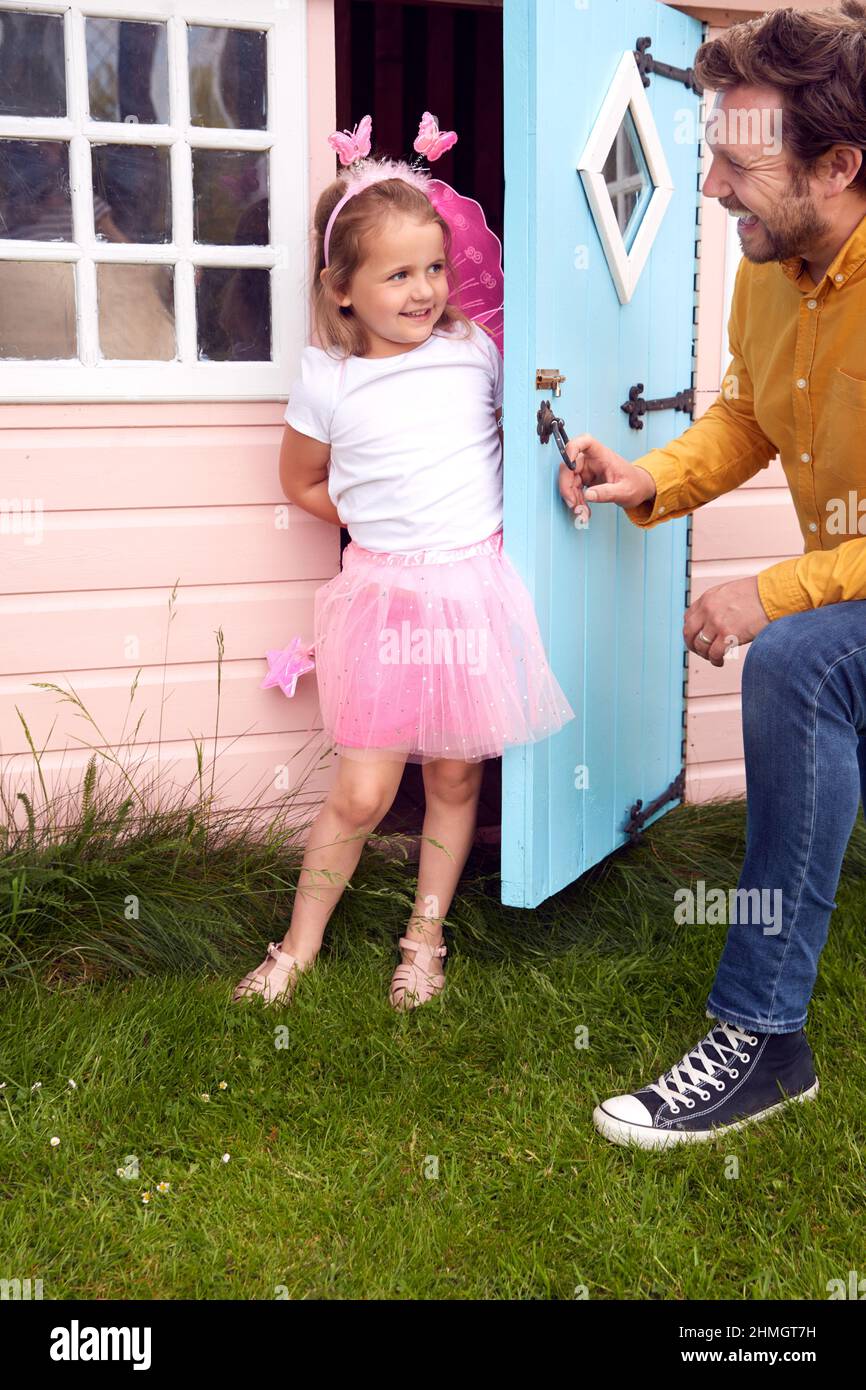Father With Daughter Wearing Fairy Costume Playing Outdoors In Garden ...