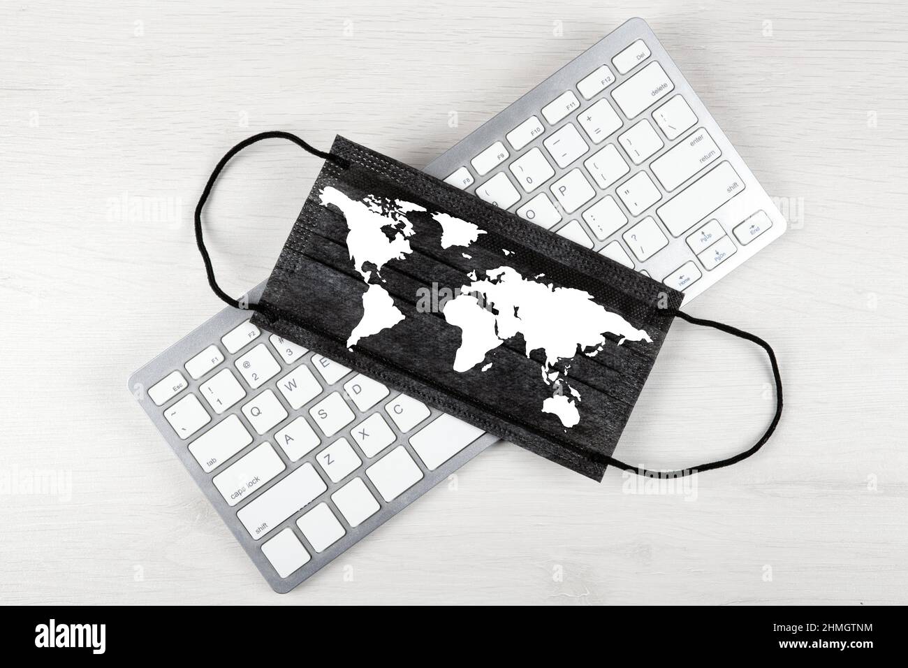 medical mask with world map on the pc keyboard on the table top view ...