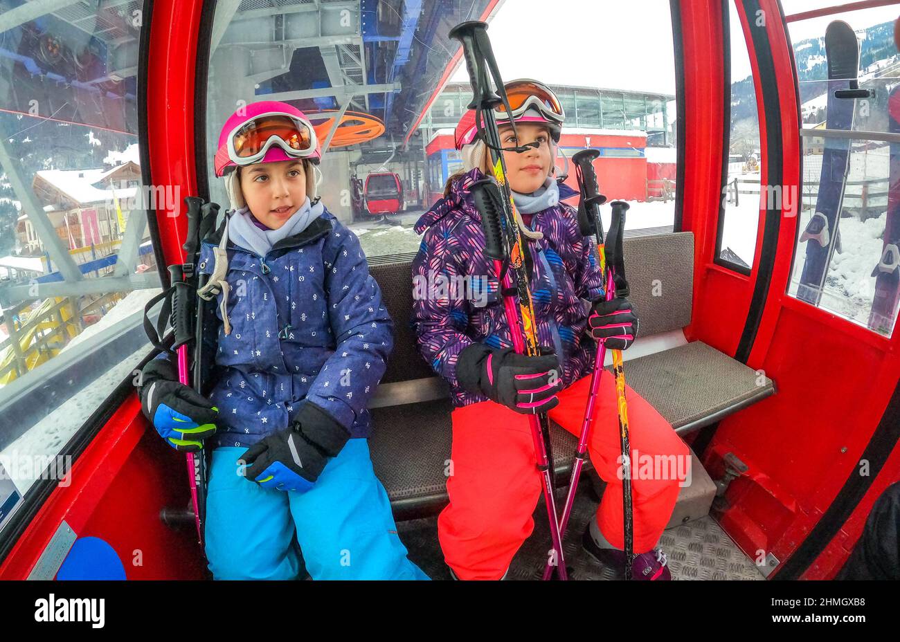 Children riding cabin cable car on winter vacation skiing. Family on ...