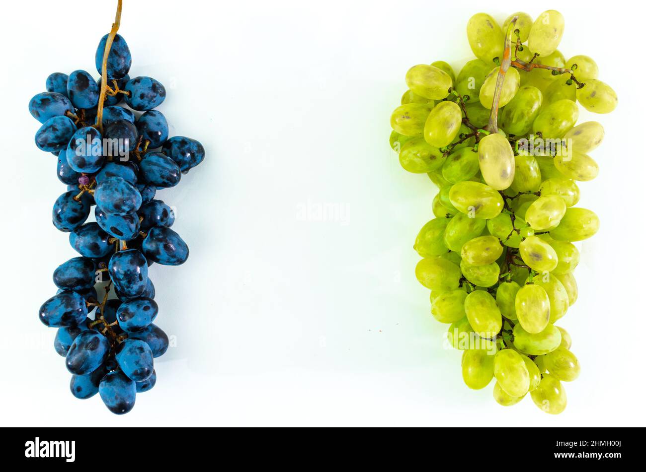 Two varieties of grapes on white background Stock Photo - Alamy