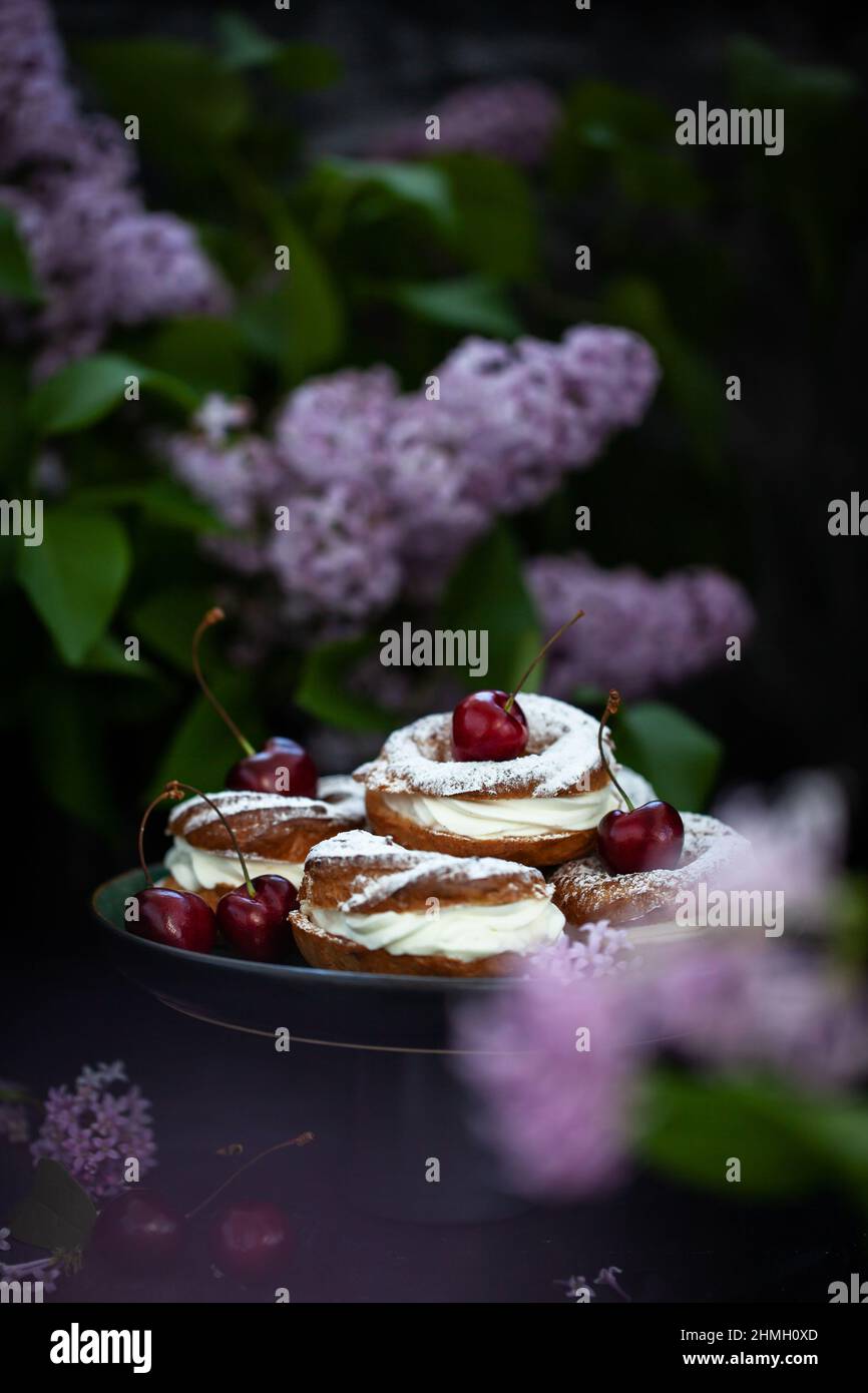 Cream puff rings (choux pastry) decorated with fresh cherry Stock Photo ...