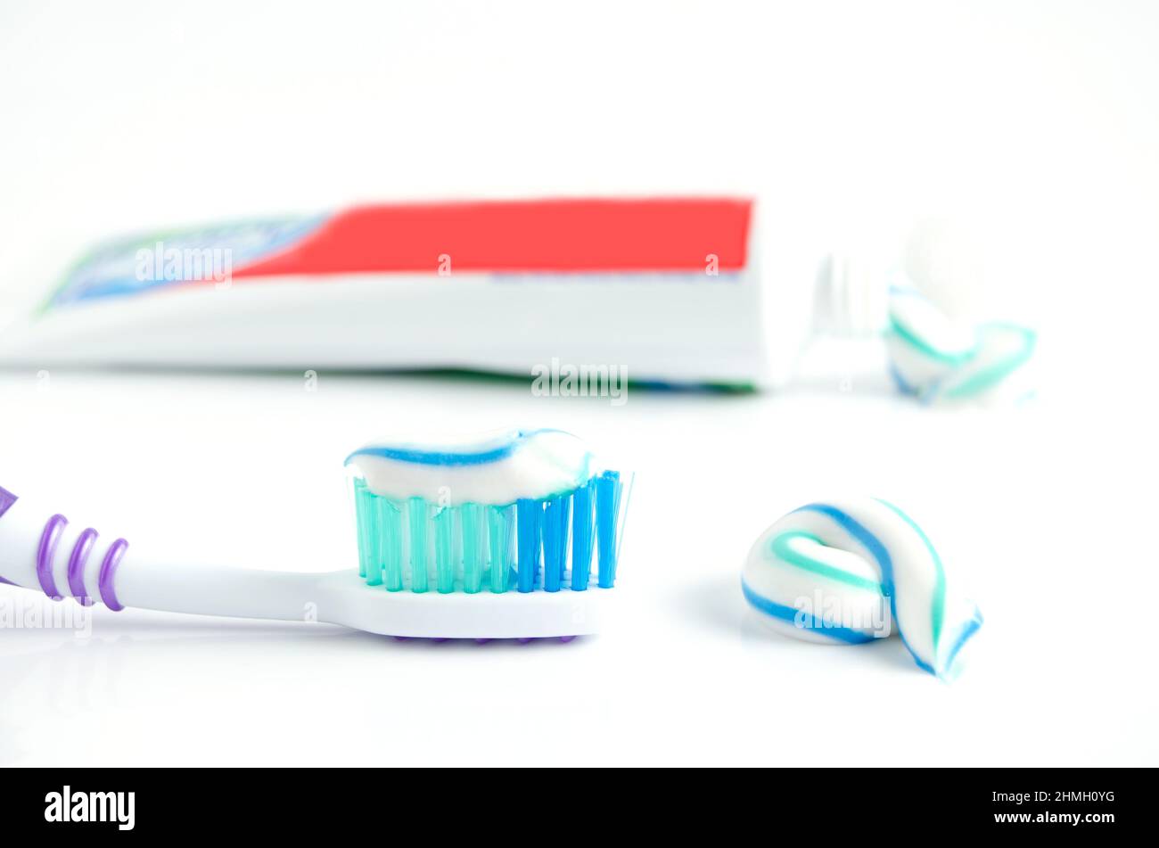 A tube of toothpaste and a toothbrush on white background closeup Stock ...