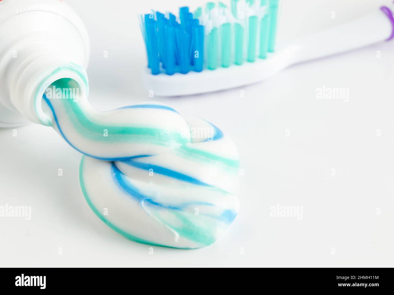 A tube of toothpaste and a toothbrush on white background closeup Stock ...
