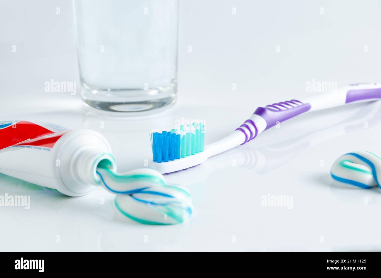 Toothbrush, tube of toothpaste and a glass on a white background Stock ...