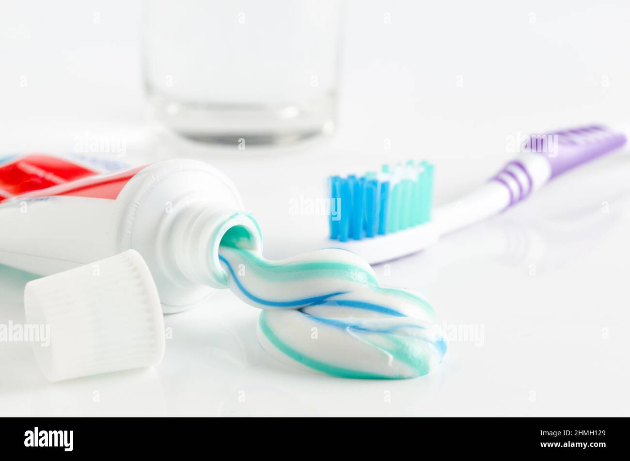 Toothbrush, tube of toothpaste and a glass on a white background Stock ...