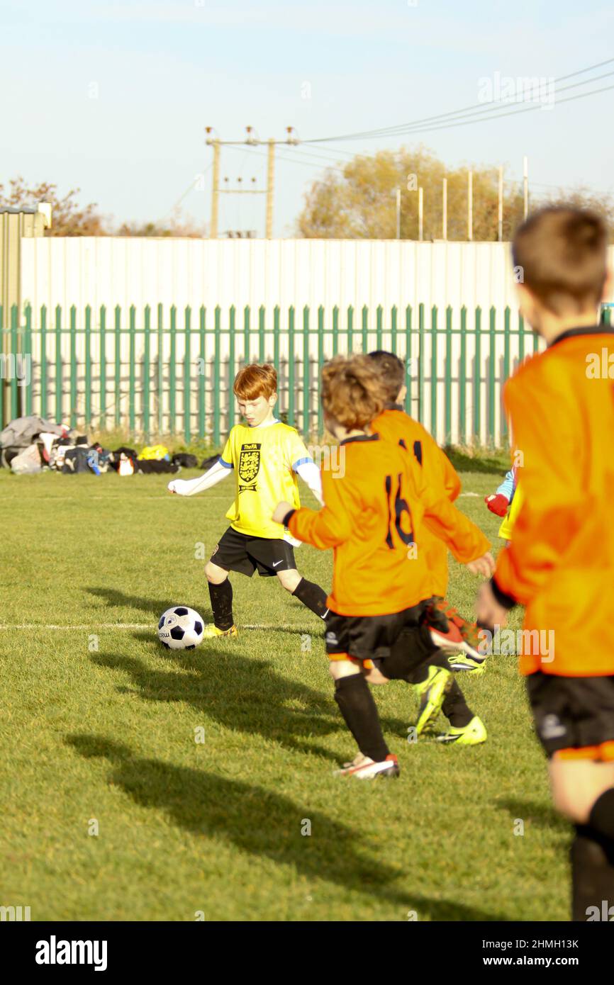 Primary school children playing football hi-res stock photography and ...