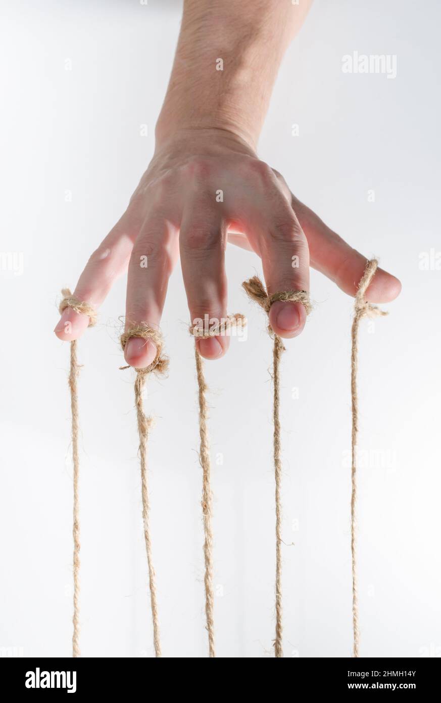 The human hand controls the puppet with the fingers attached to them ...