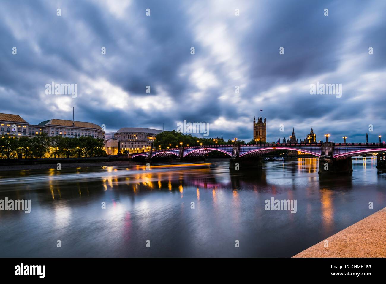 Dusk, the early evening purple lights and boat trails on the River ...
