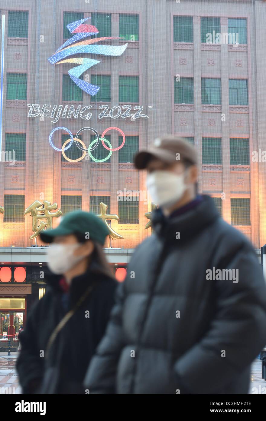 BEIJING, CHINA - FEBRUARY 10, 2022 - People walk past winter Olympic ...