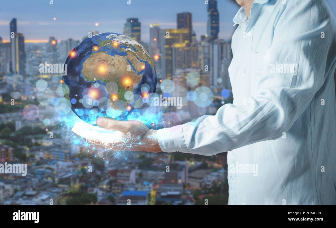 Businessman holding the Earth in his hand [Elements of this image ...