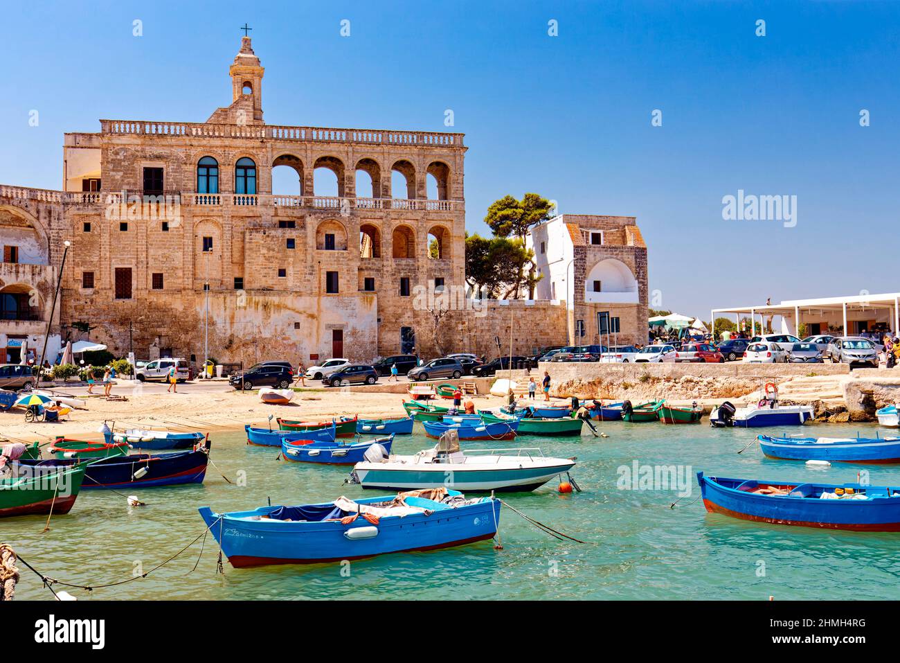 Fishing boats float on the water in Polignano a mare Stock Photo - Alamy