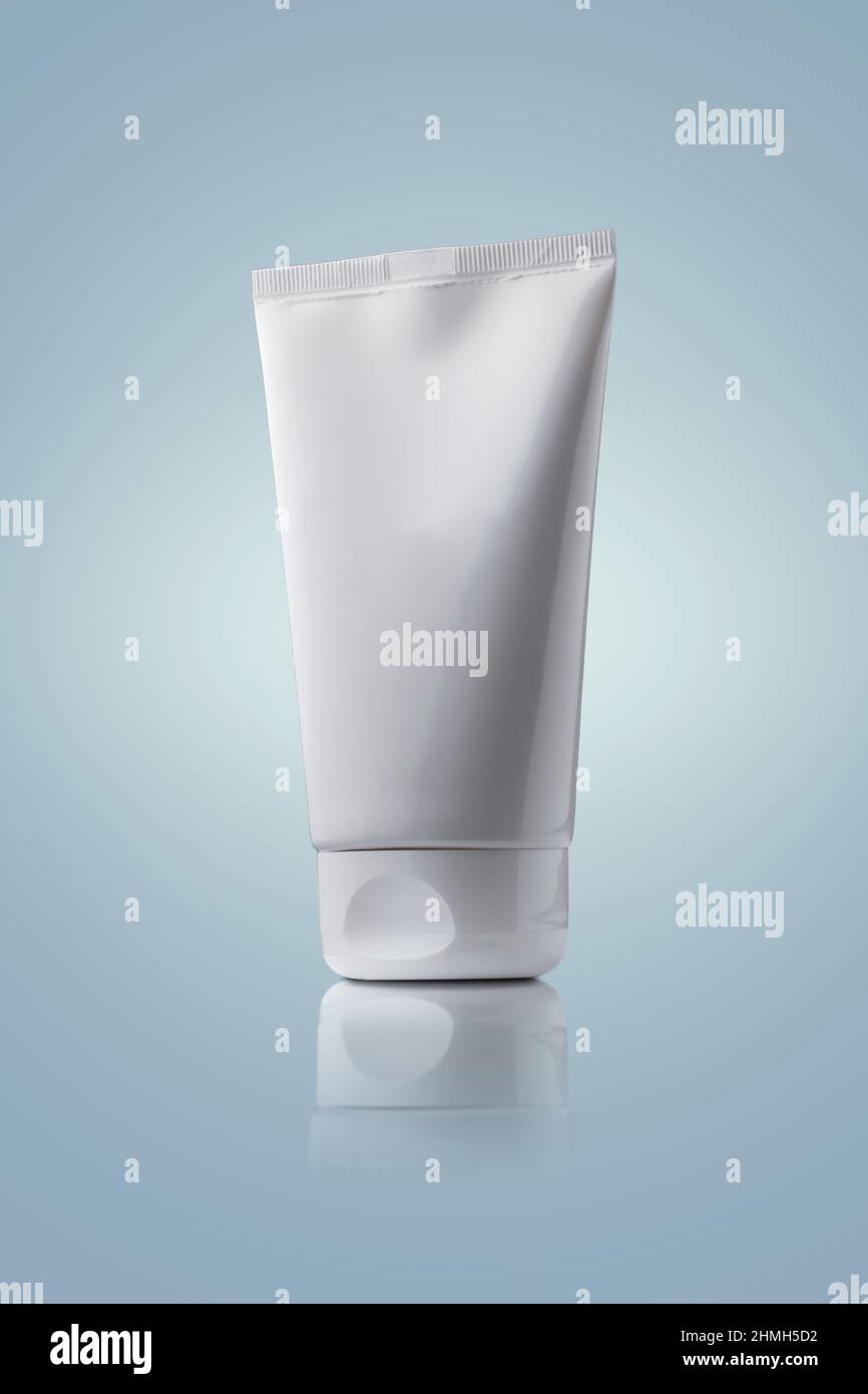 Cream tube on light blue background. Skin care concept with copy space ...