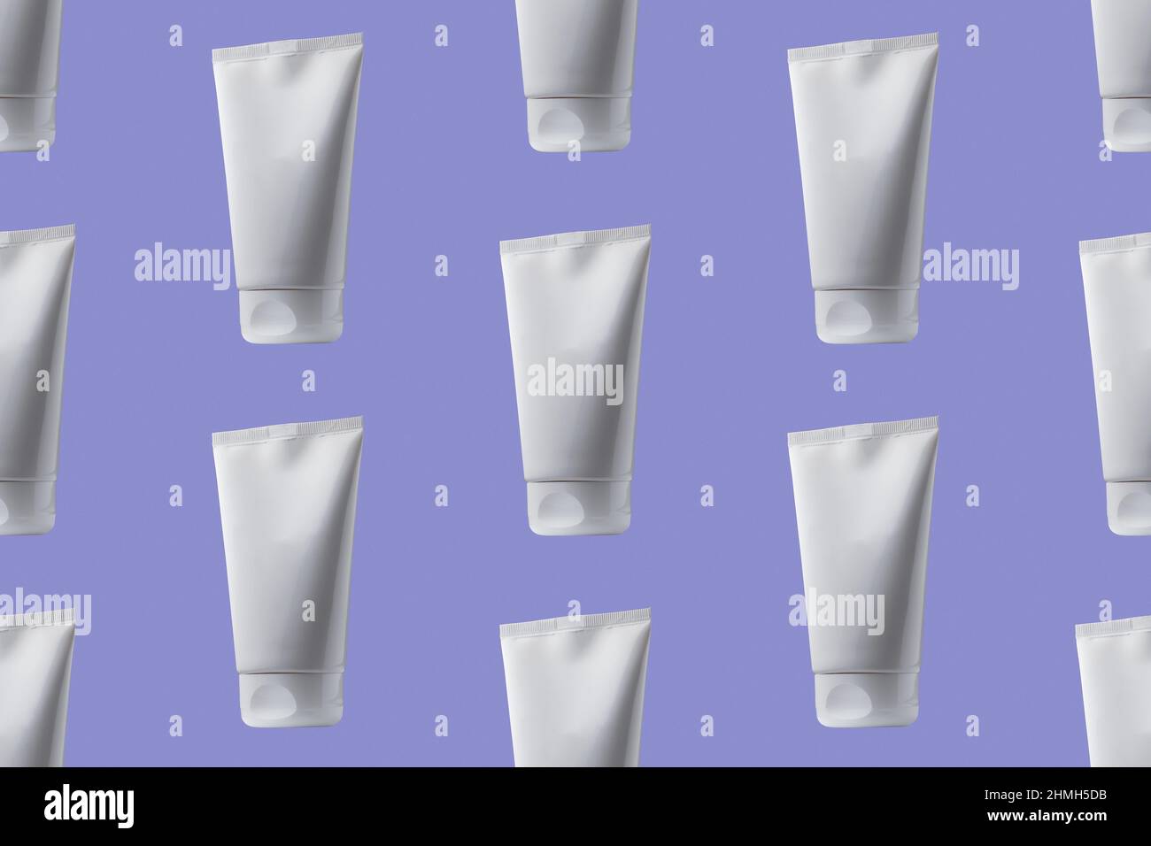 Cream tubes pattern on lilac background. Skin care concept with copy ...
