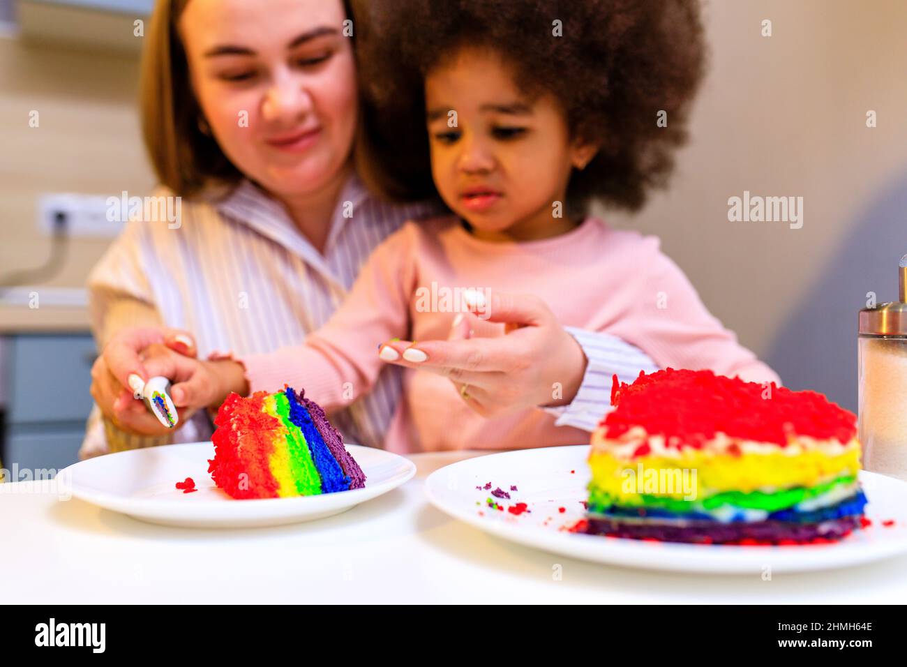happy multiethnic family eating rainbow cake at kitchen Stock Photo - Alamy