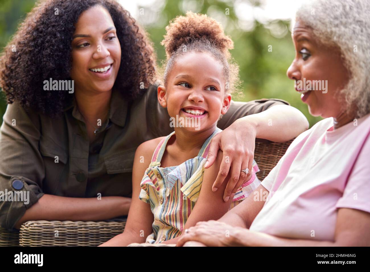 Smiling Multi-Generation Female Family At Home In Garden Together Stock ...