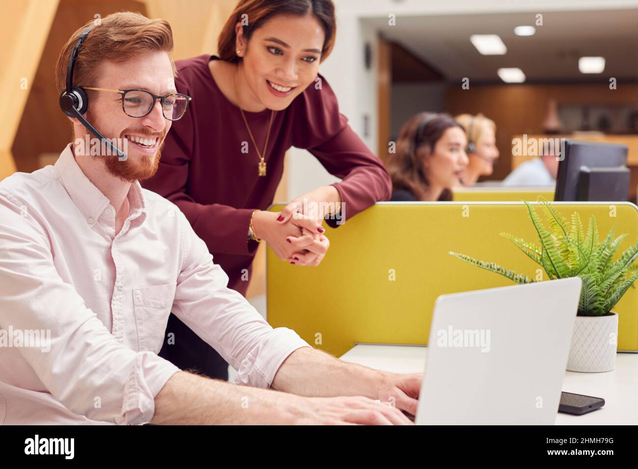 Woman talking to male customer desk hi-res stock photography and images ...