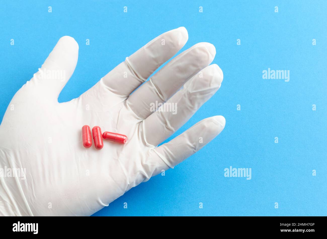 The hand of the medical worker in the medical white gloves holding a ...