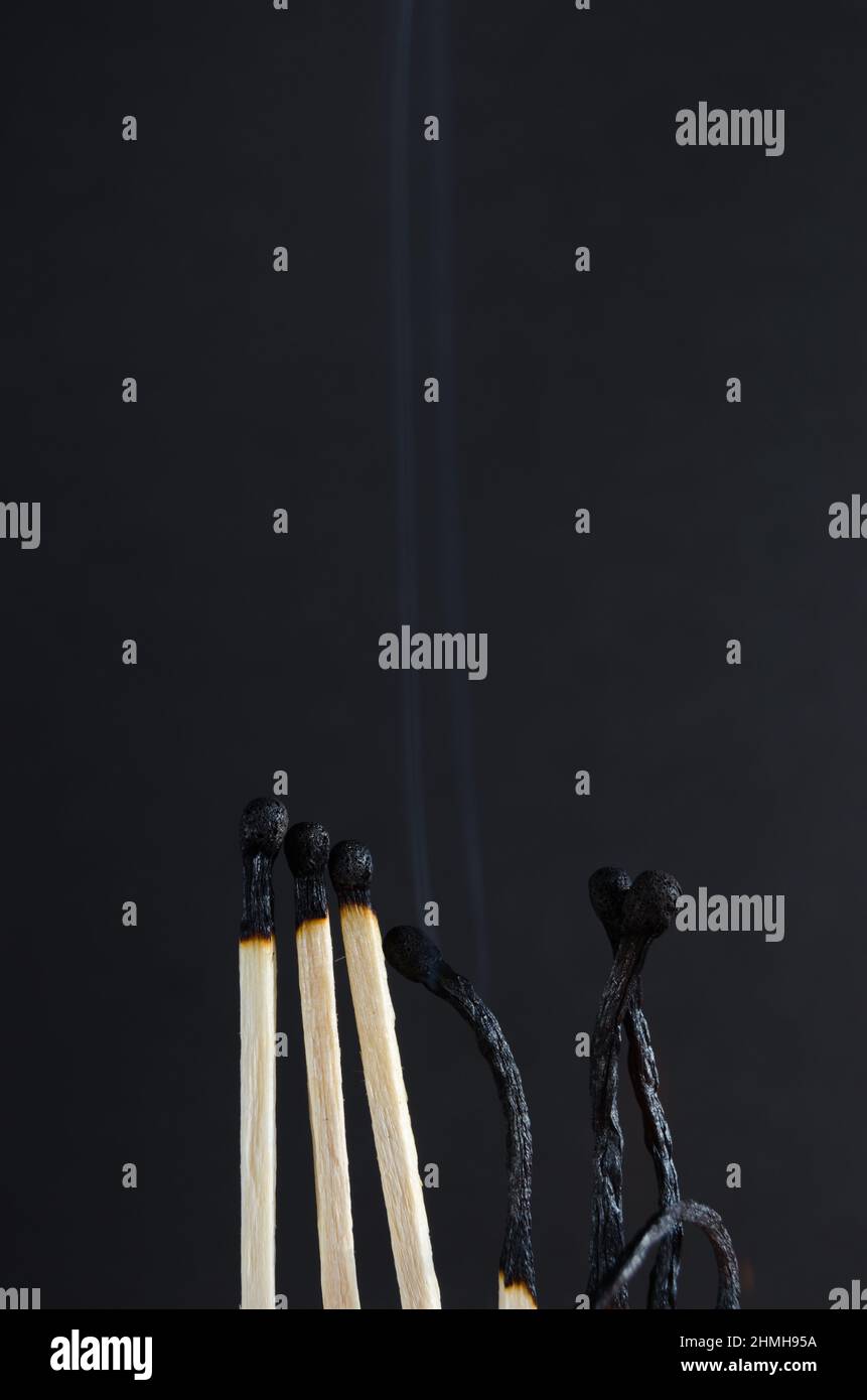 Burnt matches on a black background. Photograph of charred matchsticks ...