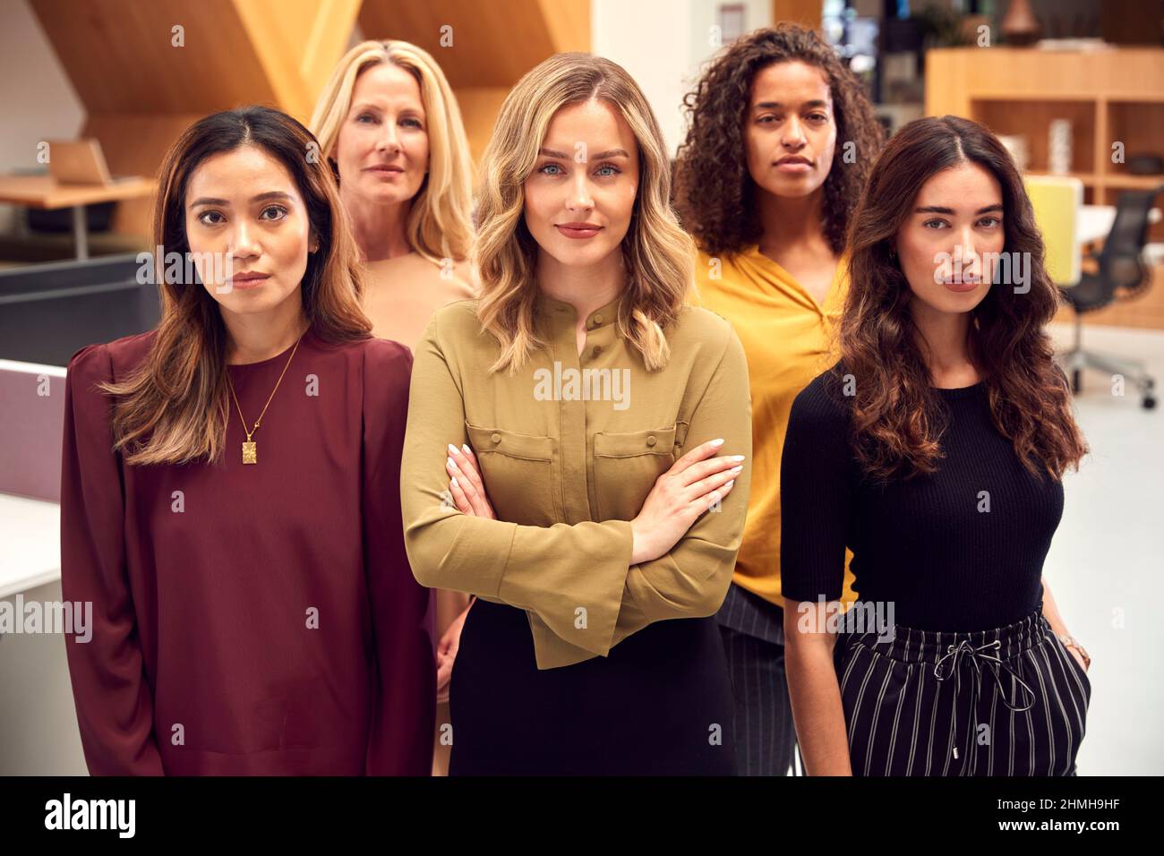 Portrait Of Multi-Cultural Female Business Team Standing In Modern Open ...