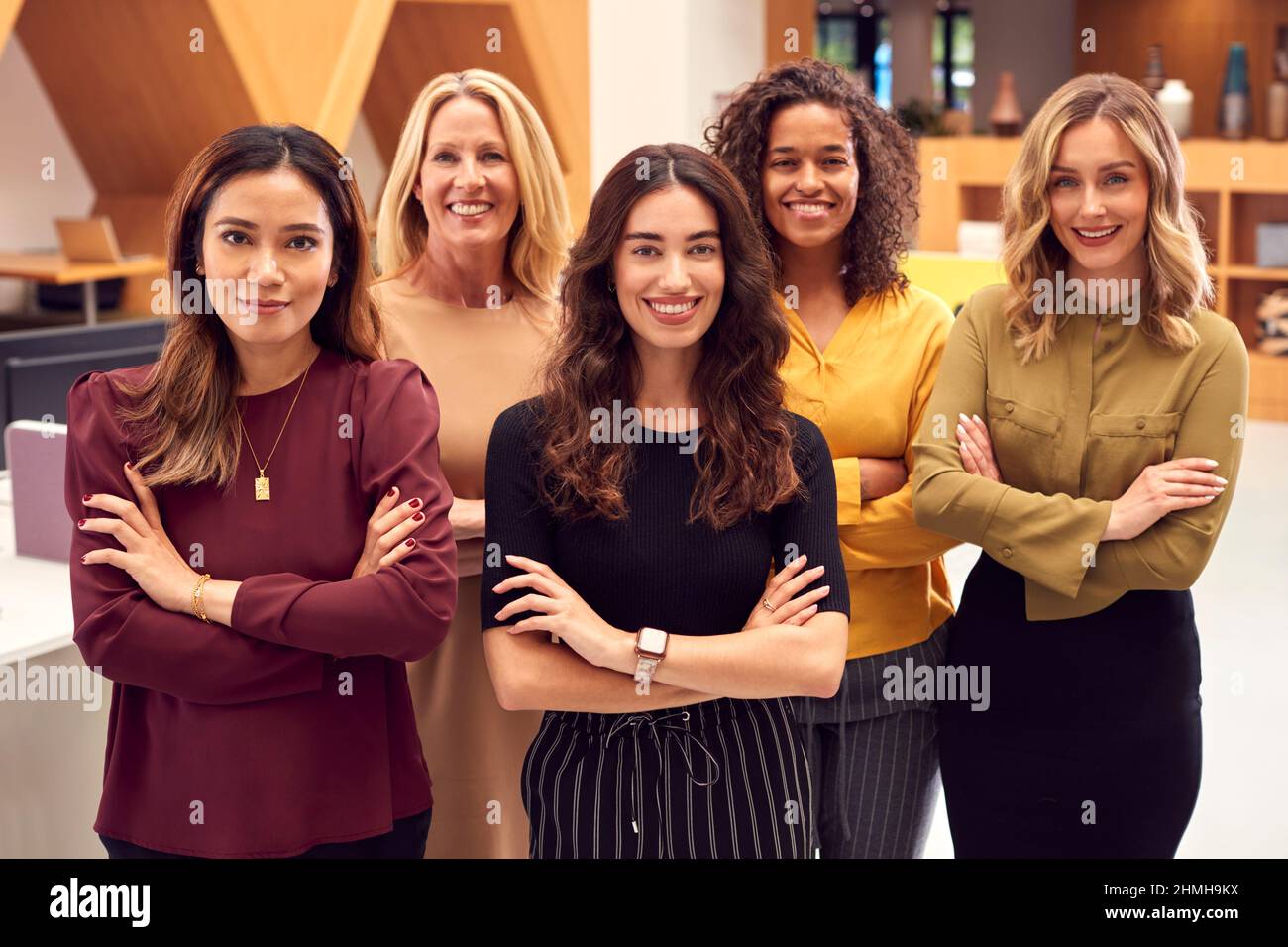 Portrait Of Multi-Cultural Female Business Team Standing In Modern Open ...