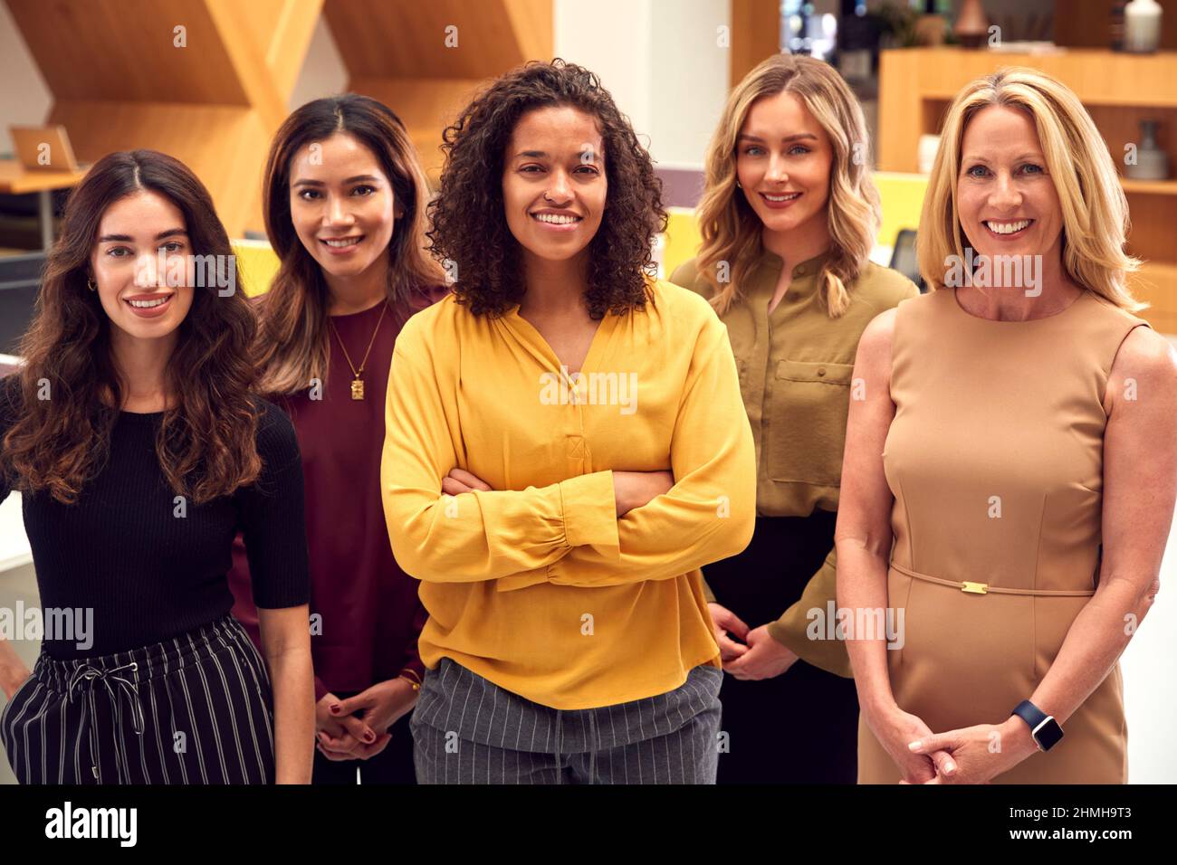 Portrait Of Multi-Cultural Female Business Team Standing In Modern Open ...