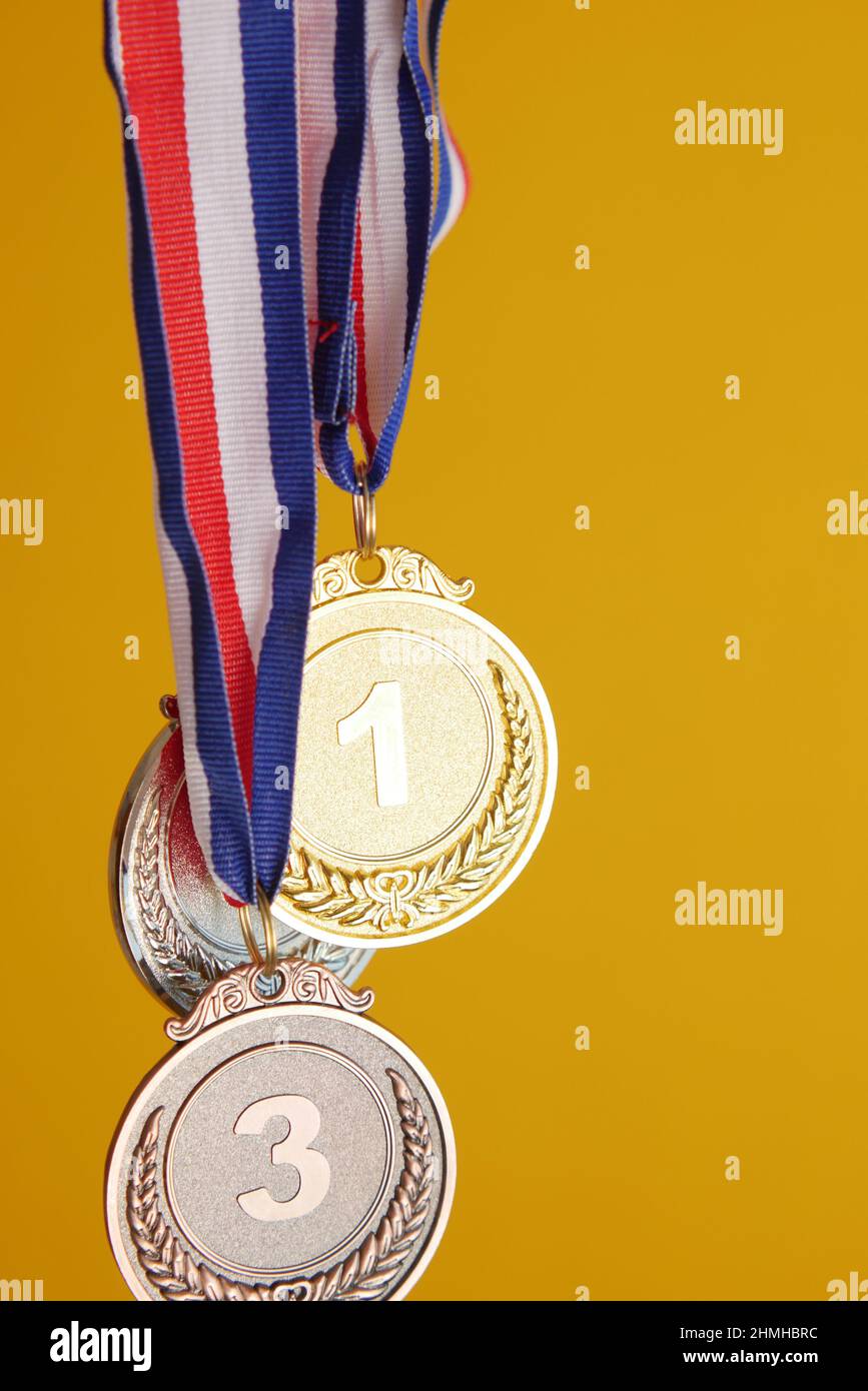 First Place Throphy against yellow background Stock Photo - Alamy