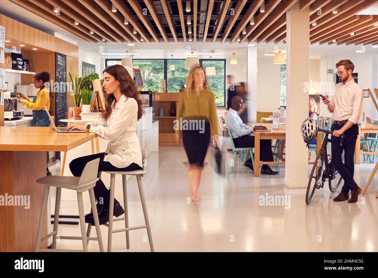 Interior Of Busy Office Coffee Shop With Businesspeople Working At ...