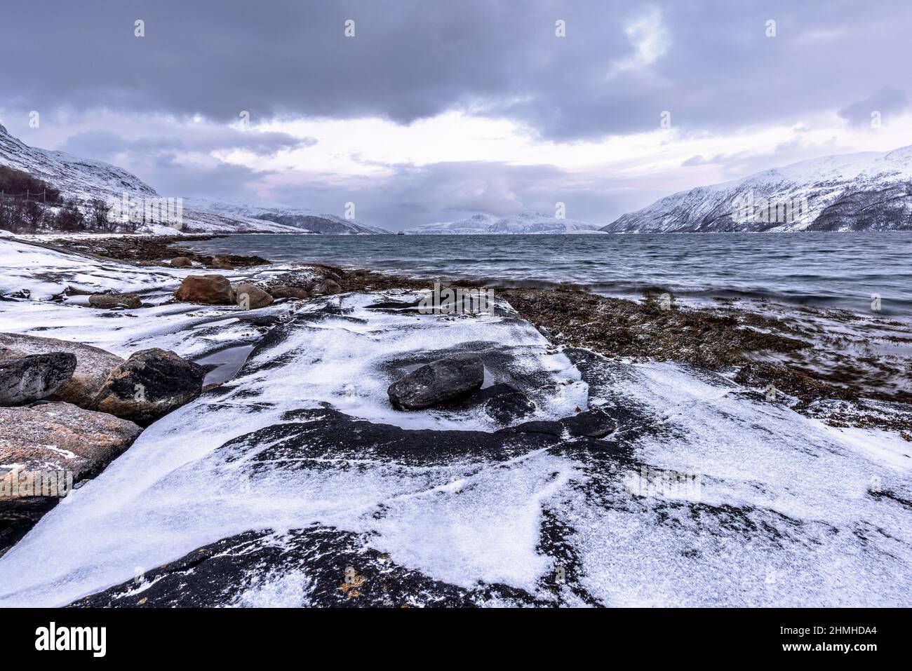 On the snow covered beach of the grotfjord in northern norway hi-res ...