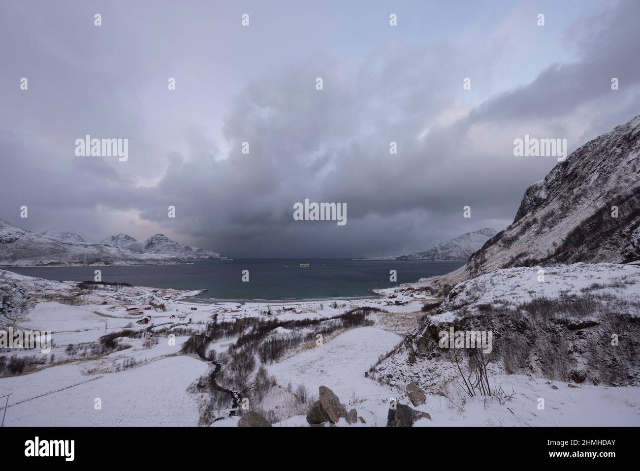 On the snow covered beach of the grotfjord in northern norway hi-res ...