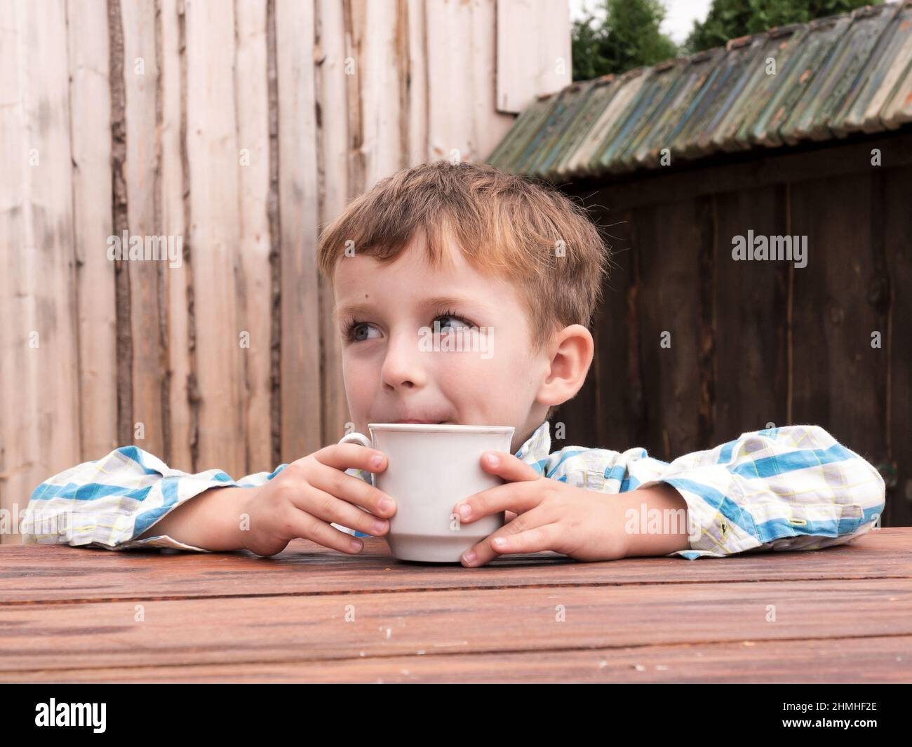Child blond boy sitting table hi-res stock photography and images - Alamy