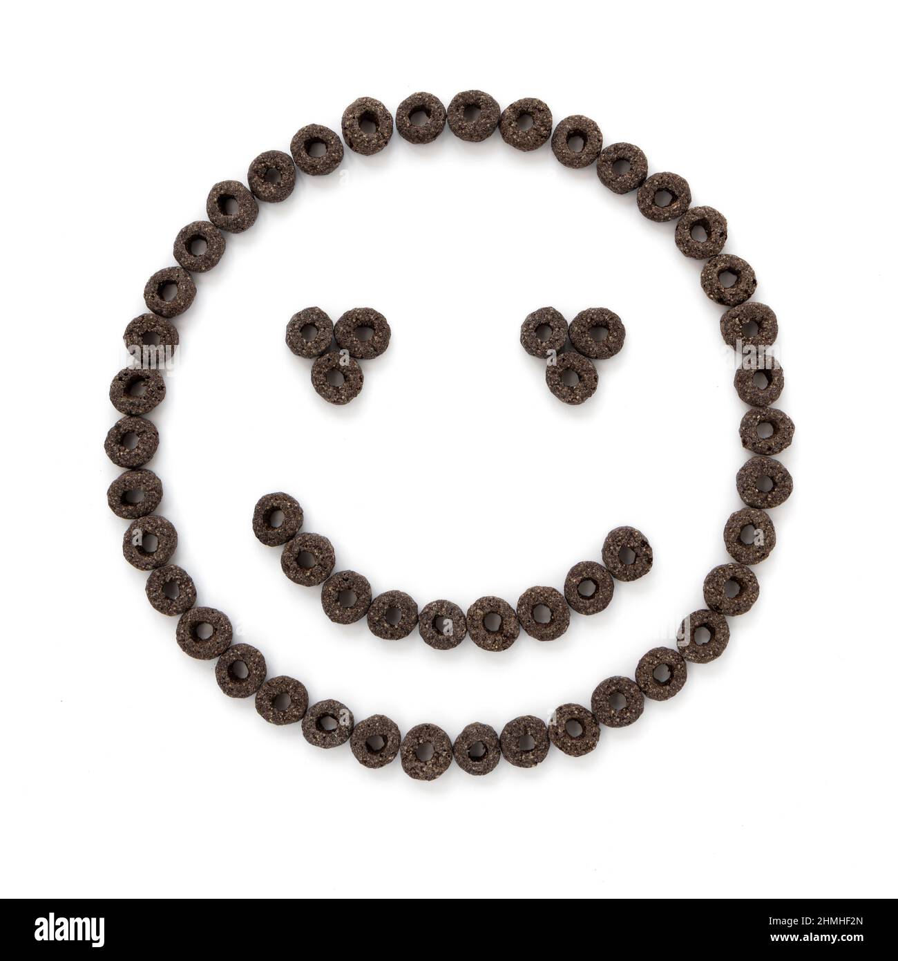 crunchy cereal rings breakfast in the shape of smiling face on white ...