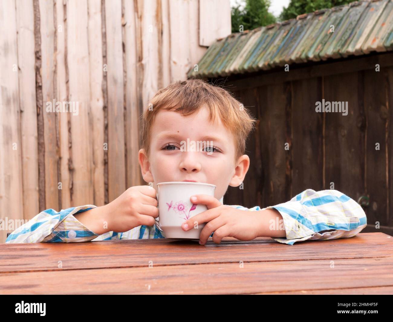 Child blond boy sitting table hi-res stock photography and images - Alamy