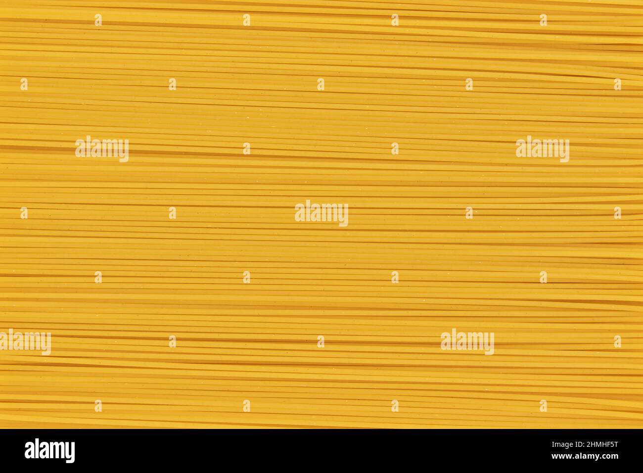 background with uncooked italian spaghetti, close up, texture of yellow ...