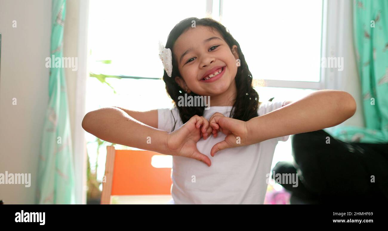 Adorable child making heart symbol with hands Stock Photo - Alamy