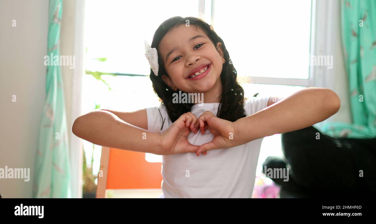 Adorable child making heart symbol with hands Stock Photo - Alamy