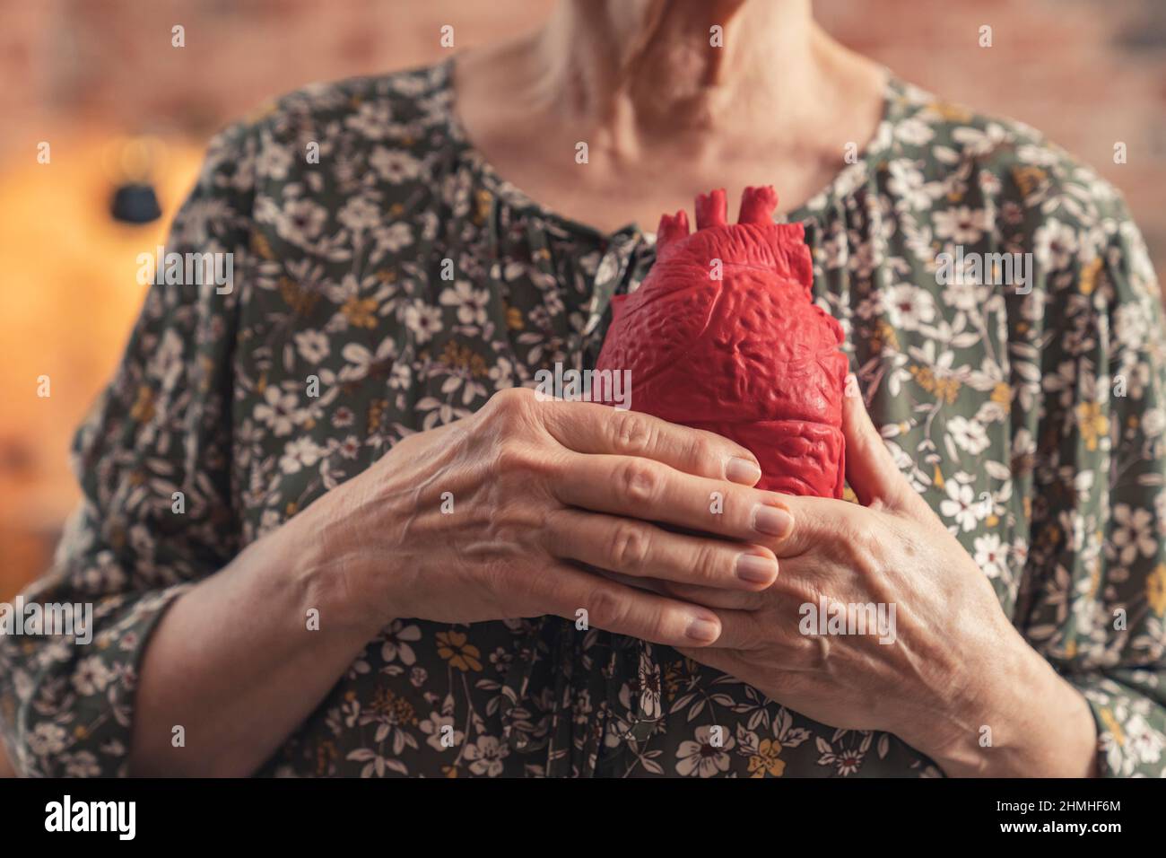 Artificial red heart held in hi-res stock photography and images - Alamy