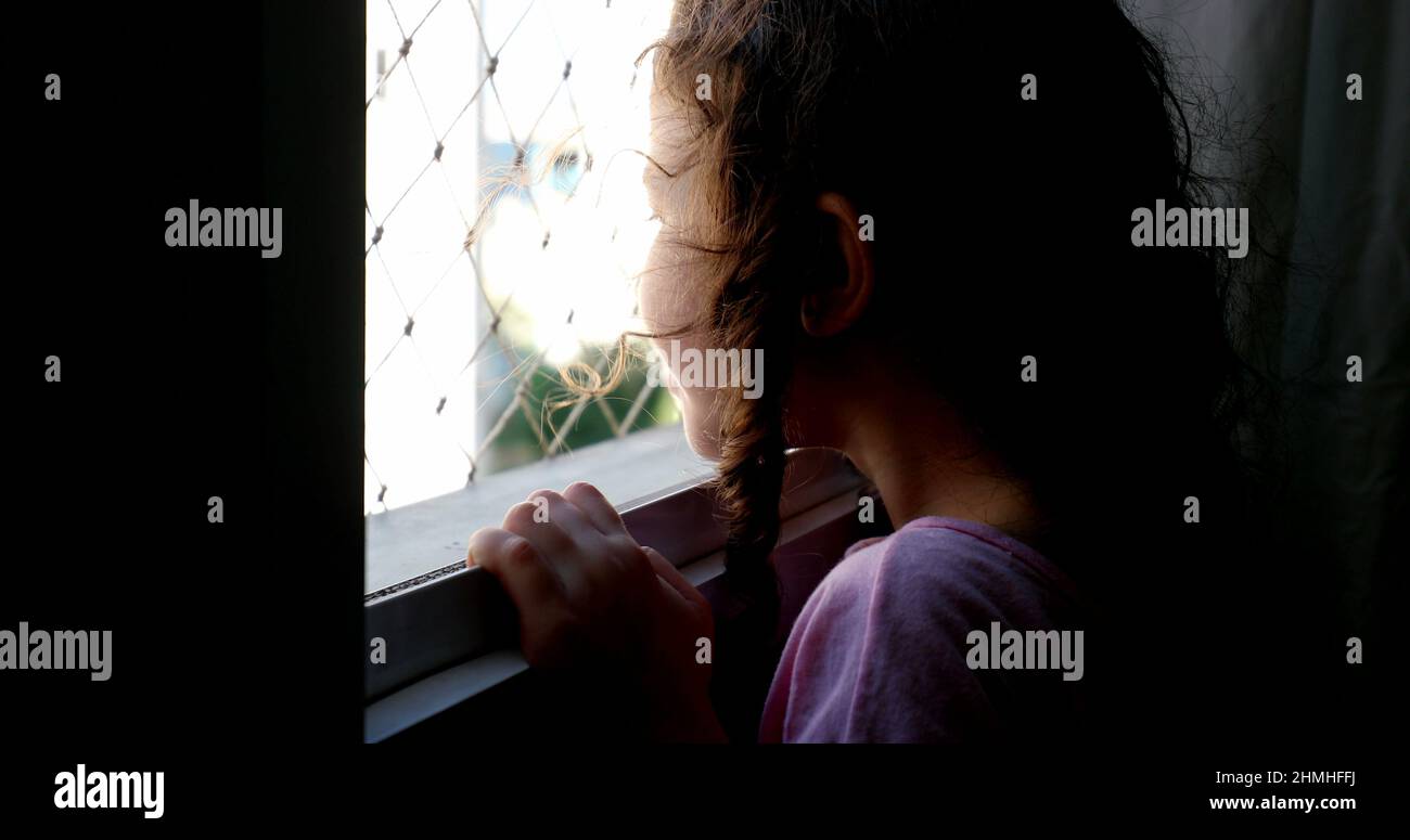 Child girl looking outside through window, kid peeking head out Stock ...
