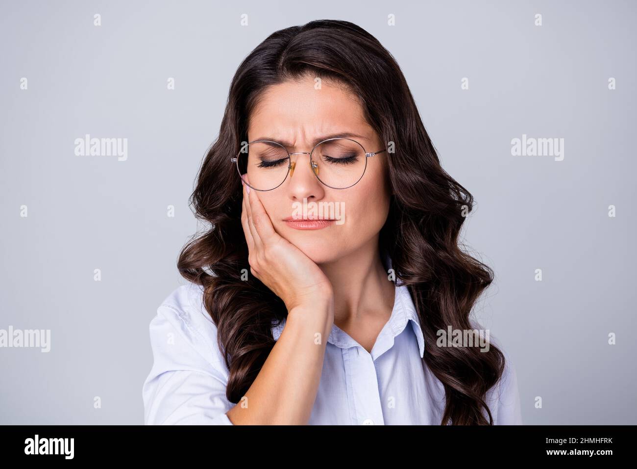 Photo of troubled annoyed lady touch cheek suffer teeth pain wear specs ...