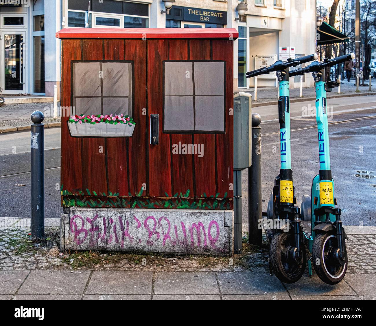 Two Tier Electric scooters parked on pavement next to painted utility ...