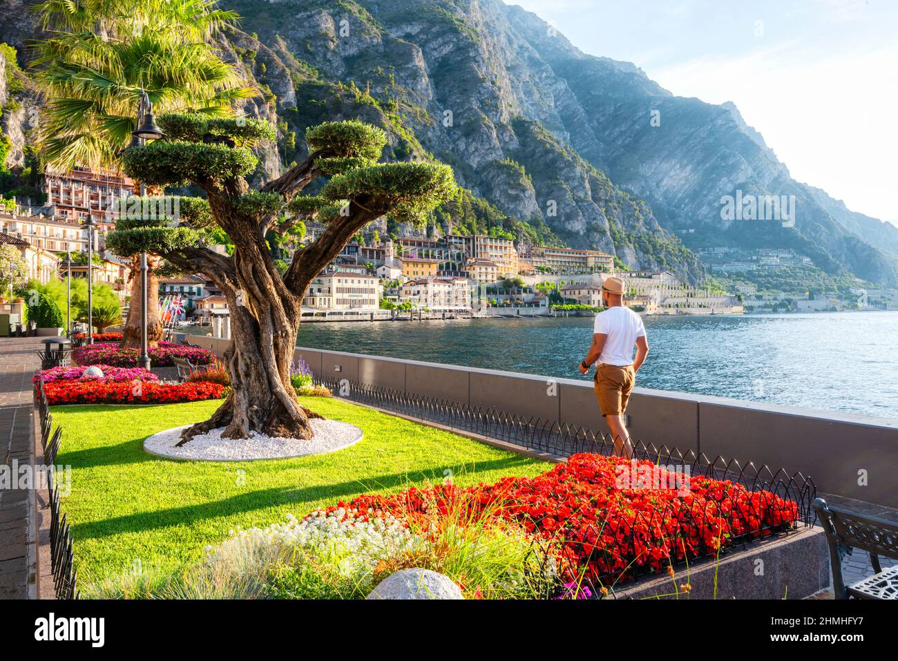 Tourist walking along the central avenue of Limone sul Garda. Europe ...