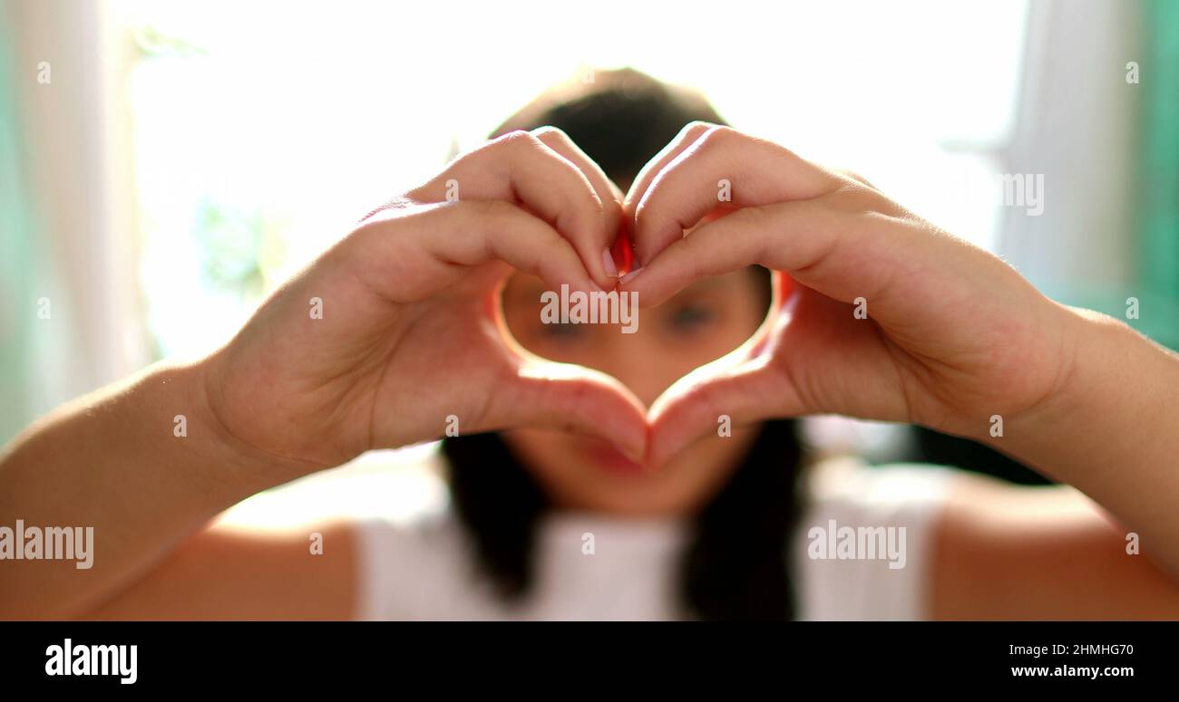 Cute child doing heart symbol sign with hands Stock Photo - Alamy